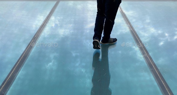Reflection of man’s legs on glass floor Stock Photo by ashiqkhan ...
