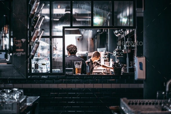 Restaurant kitchen through window workers chef working cooking moody ...