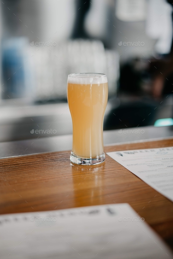 Beer glass sitting on bar brewery countertop at restaurant dining menus ...