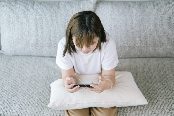 People gen Z use smartphone and social media on the living room at home ...