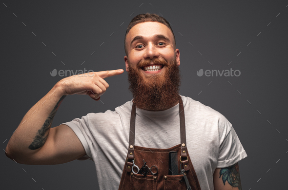 Cheerful barber pointing at beard Stock Photo by kegfire | PhotoDune
