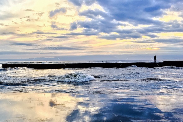 Shonan beach and reflections from dusk sky Stock Photo by Threetails05