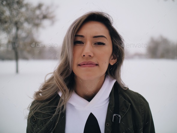 Young woman looking directly at camera smirk happy peaceful outside in ...