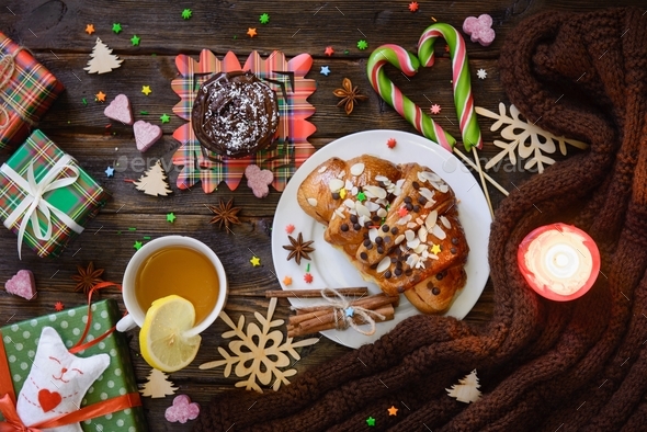 Christmas morning table with croissant (bakery), sweets and gifts. Top ...