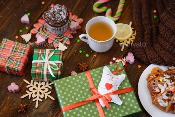 Christmas morning table with croissant (bakery), sweets and gifts. Top ...