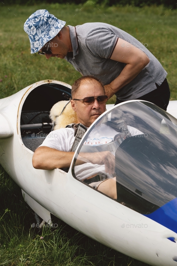 Glider pilot getting ready for flight on small motorless aircraft ...