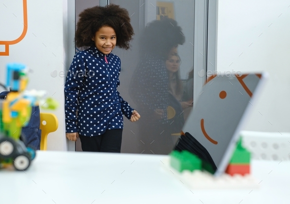 Black Girl at school entering class for lesson Stock Photo by ninelutsk