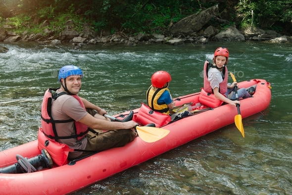 Family starting rafting on a mountain river. Father, mother and son ...