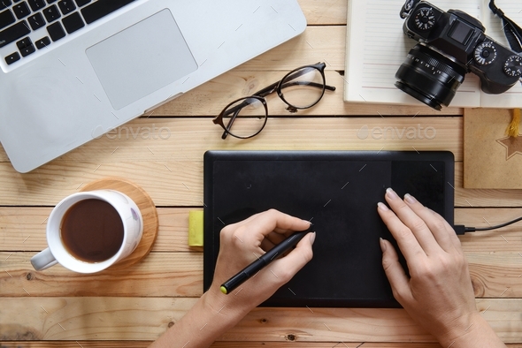 Graphic designer using graphic tablet in digital work and photo editing ...