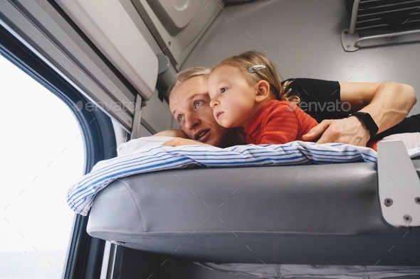 Father with child travalling in train, having fun enjoying scene ...