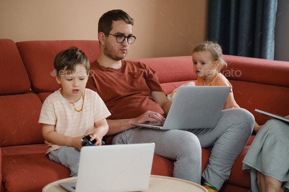 Big happy family with children watching movies playing games on laptop ...