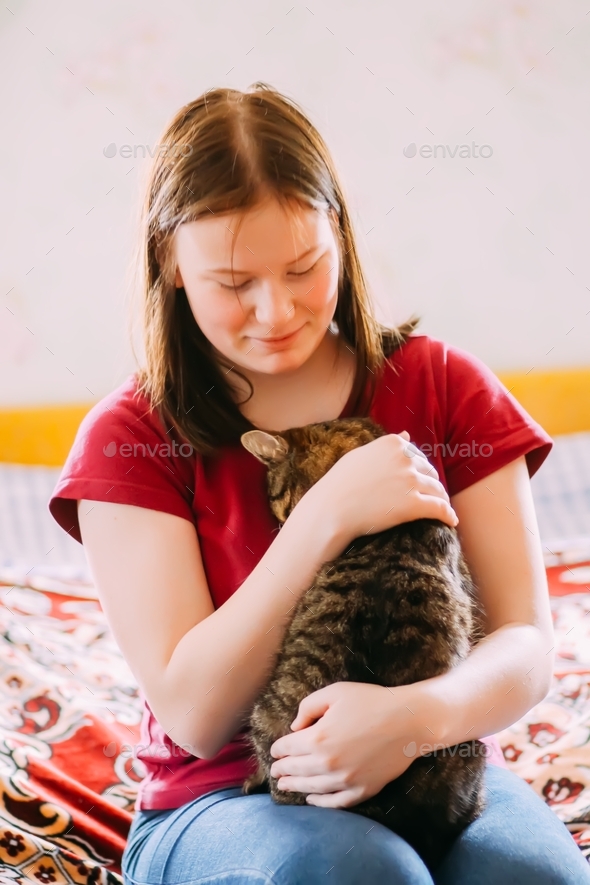Teenager girl with a cat at home. Stock Photo by Pictures_for_You ...