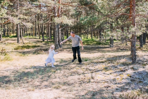 Adult man and little girl playing in a spring park. Stock Photo by ...