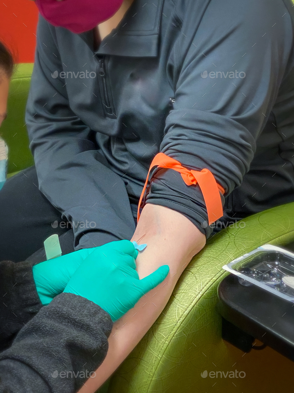 Person Getting stuck with a needle to draw blood Stock Photo by bwise346