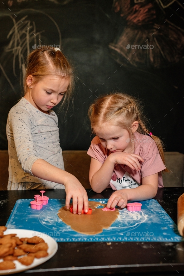Little girls, sisters cooking homemade cookies Stock Photo by Julia_Axa