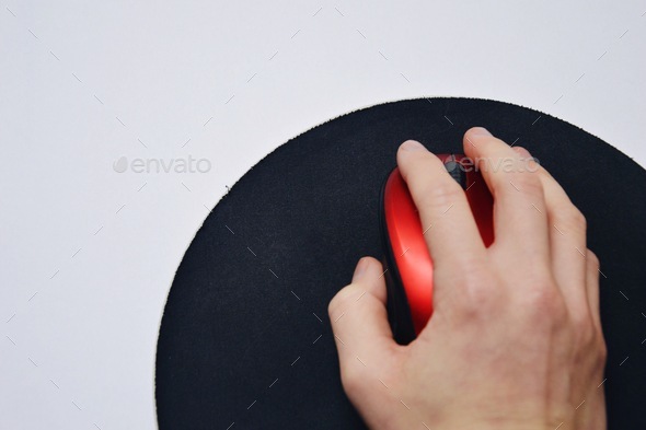 Overhead photo of a hand holding a red wireless computer mouse Stock ...