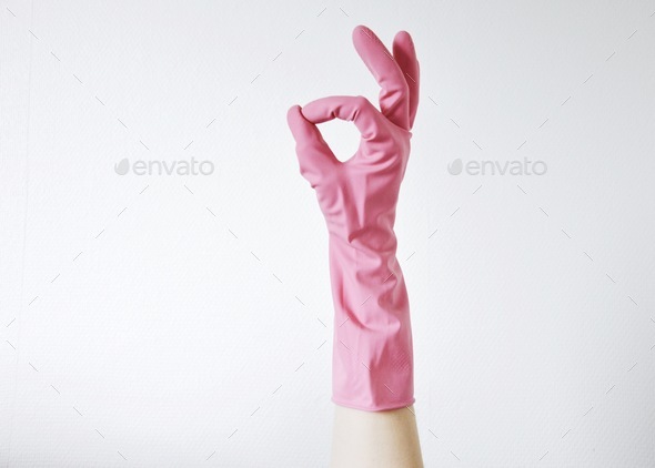 Photo of hand sign in pink cleaning gloves on a white background Stock ...