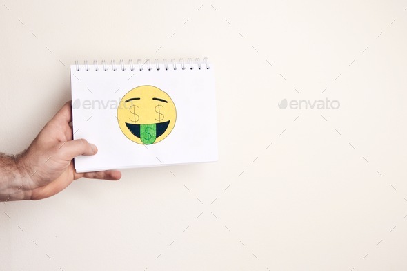 Hand holding a notebook with drawing of a smiley Stock Photo by lindaze