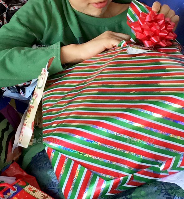 Christmas moments. The happiness of unwrapping a gift on Christmas ...