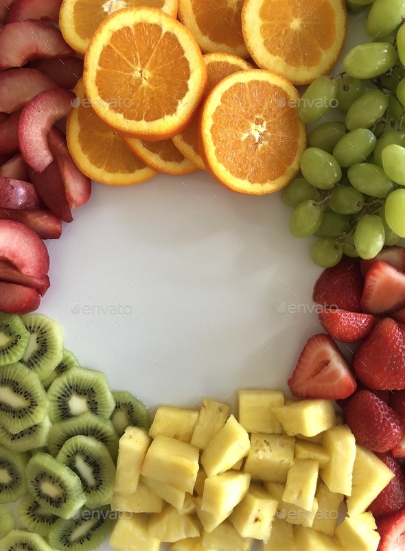 Overhead of colorful healthy fresh cut fruit background with copy space ...