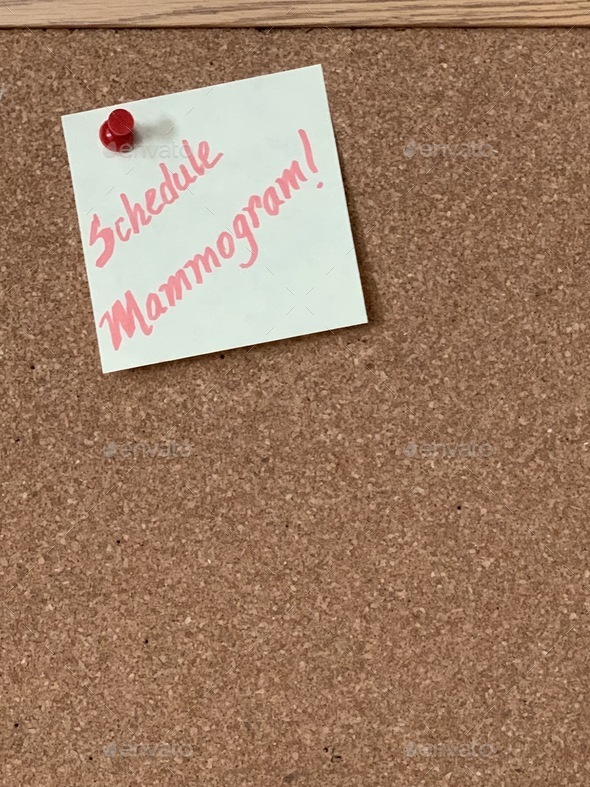 Breast cancer awareness. “Schedule mammogram” post it note reminder on ...