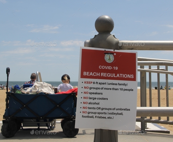 Guidelines sign at the beach entrance, announcing the new rules ...
