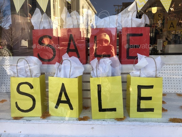 Sales, sales and mores sales signs through the store’s window while ...
