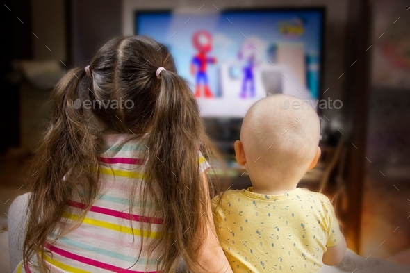 Older sister and little brother watch cartoons on TV. Stock Photo by ...