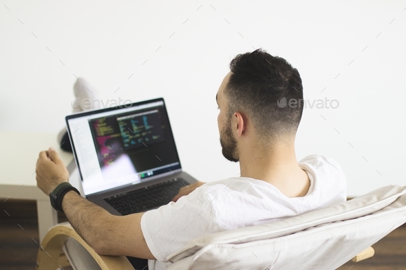 Man working on laptop. Programming at home. Home office. Stock Photo by ...