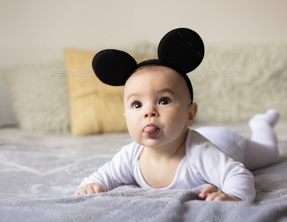 Little beautiful child in a Mickey Mouse costume. Mickey Mouse ears ...