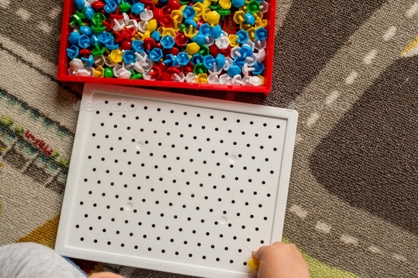 Toddler child early development. Mosaic pegboard game Stock Photo by ...