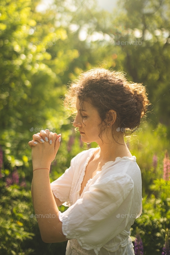 The girl is praying. Prayer to God. Believer. Hope and Prayer. Faith ...