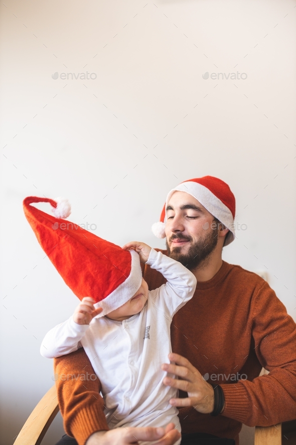 Dad and his son are getting ready to celebrate Christmas. Dad and son ...