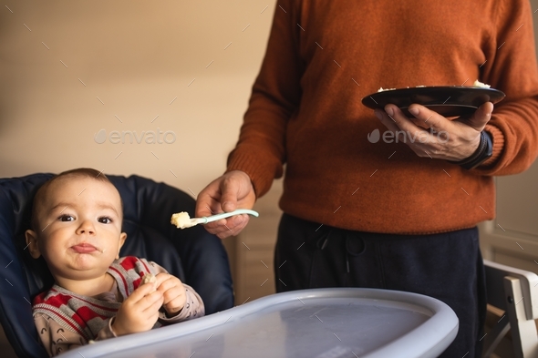 Little boy is learning to eat. Complementary feeding of the child. The ...