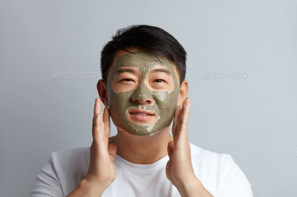 Asian Man Face Mask. Closeup Of Healthy Handsome Male Applying Green ...