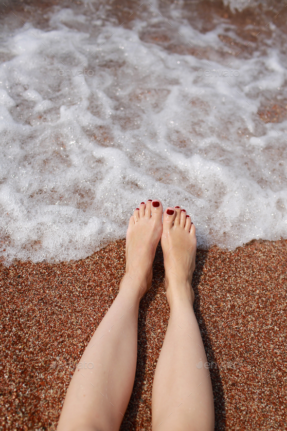 Travel Concept Womans Legs On Beautiful Tropical Beach With Pebble