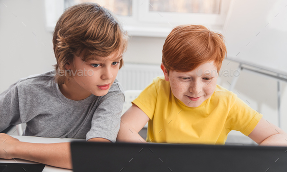 Happy kids studying computer science in classroom Stock Photo by kegfire