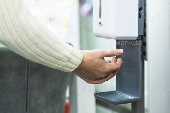 Cleaning, washing hands using automatic sanitizer dispenser concept ...