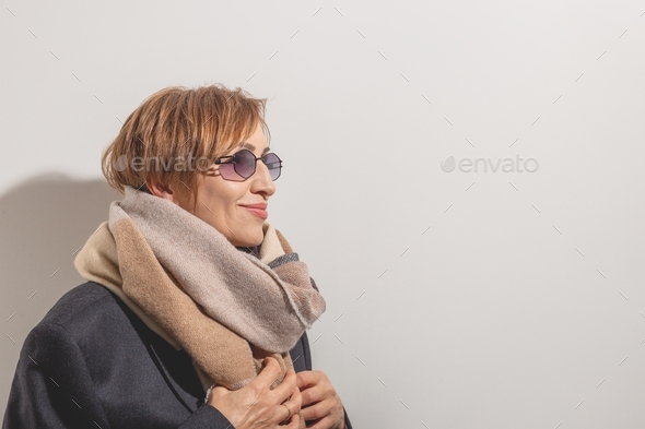 Beautiful baby boomer woman of middle age in sunglasses smile and ...