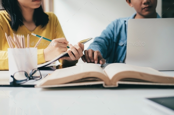 Young woman and man studying for a test or an exam Stock Photo by ijeab