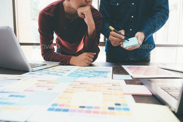 Creative graphic designer team working together. Stock Photo by ijeab