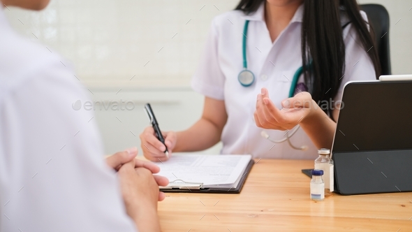 Doctor explaining and giving a consultation to a patient medical ...