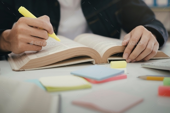 Highlighter in male hand marked text in book, education concept. Stock ...