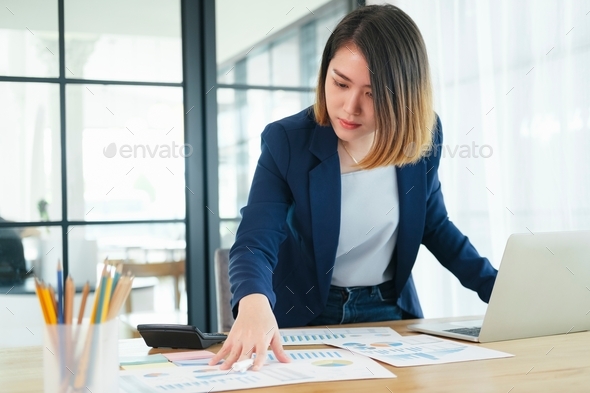 Portrait of business professional lady working at computer in the ...