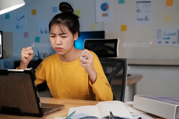 Picture of angry overworked young woman in home office. Stock Photo by ...