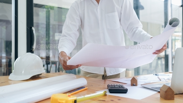 Engineers Working With Blueprint Stock Photo by ijeab | PhotoDune
