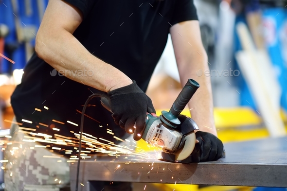 Metalwork craftsman cutting metal with grinder tools. Stock Photo by ...