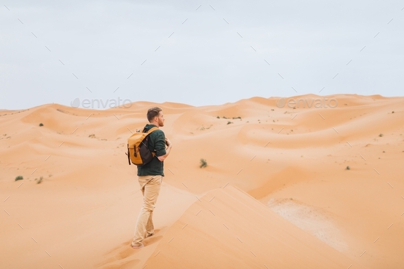 Man backpacker travel in Morocco, Sahara desert. Explore african nature ...
