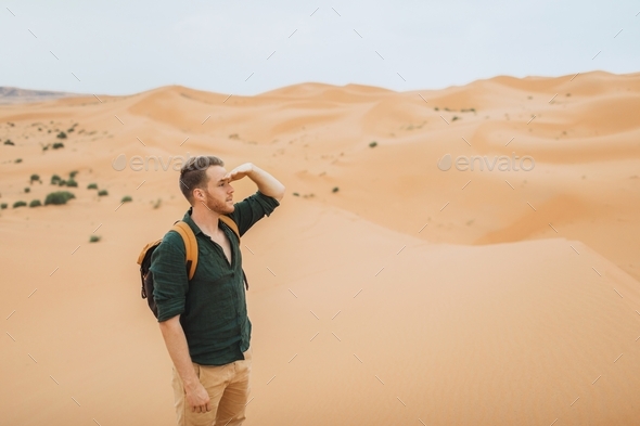 Man backpacker travel in Morocco, Sahara desert. Looking forward and ...