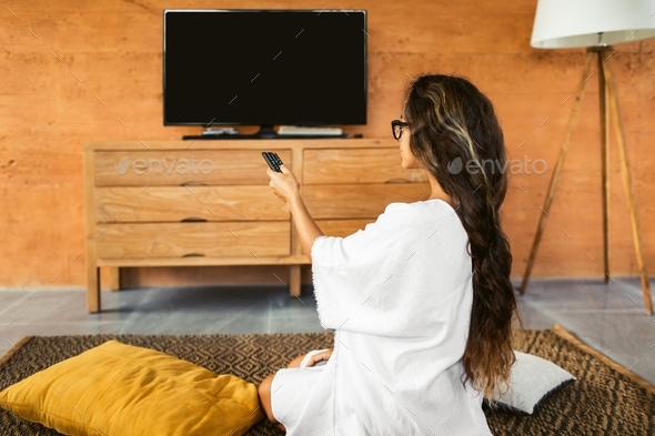 Entertainment at home, tv addiction. Stay home. Woman switch channels ...